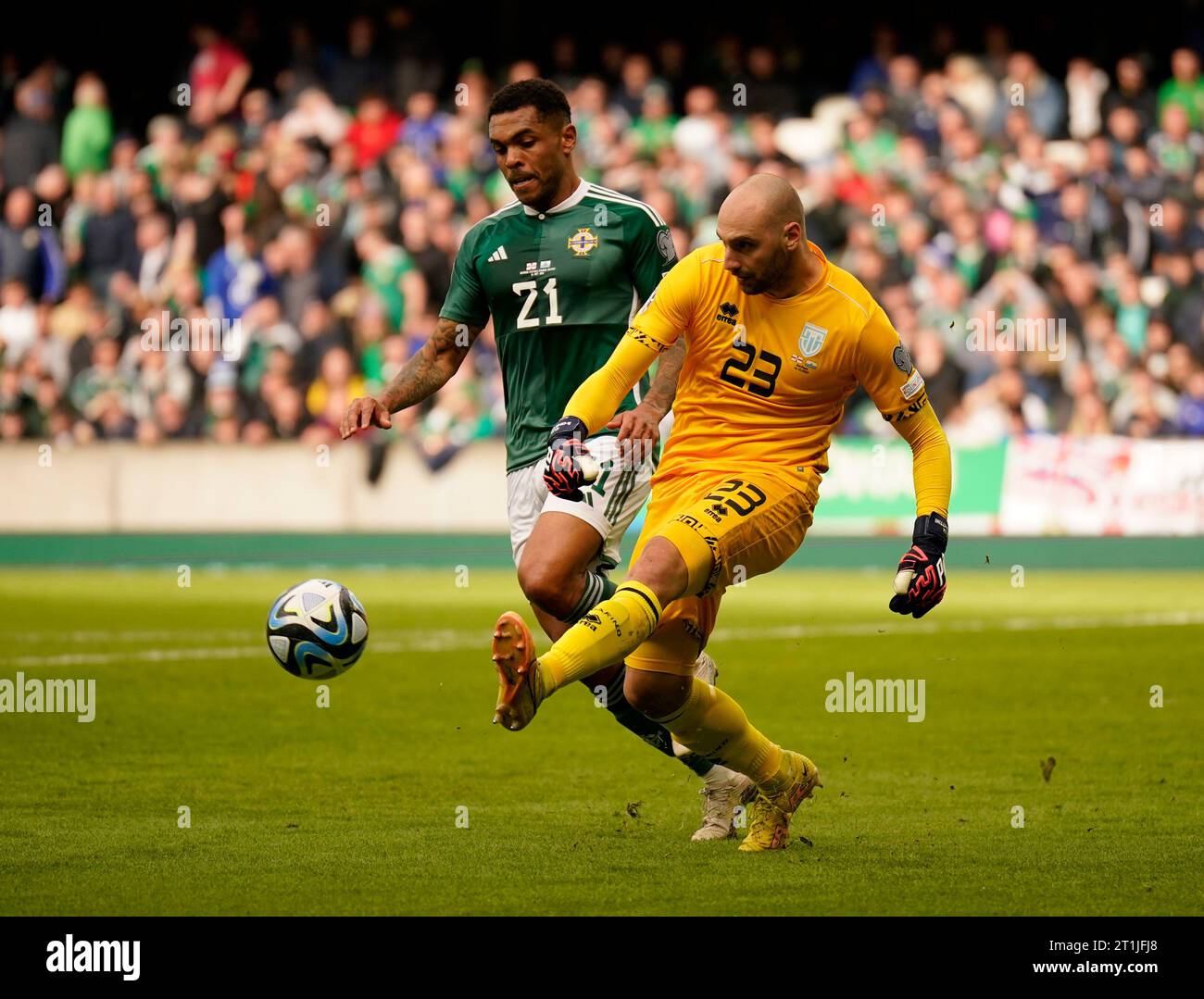 Northern Ireland's Josh Magennis (left) puts San Marino goalkeeper Elia ...