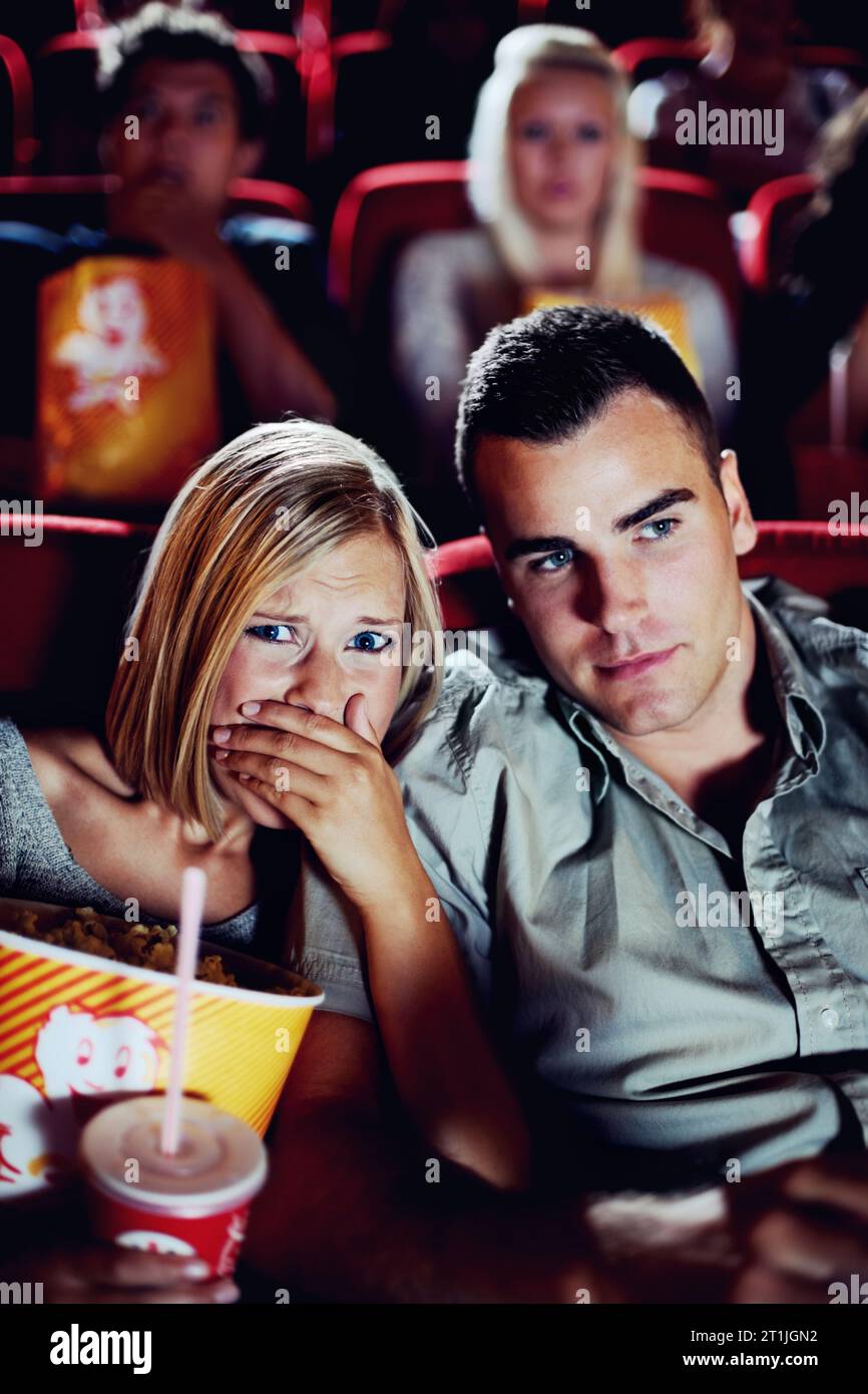 Cinema, horror and couple with popcorn, watching film and shock on ...