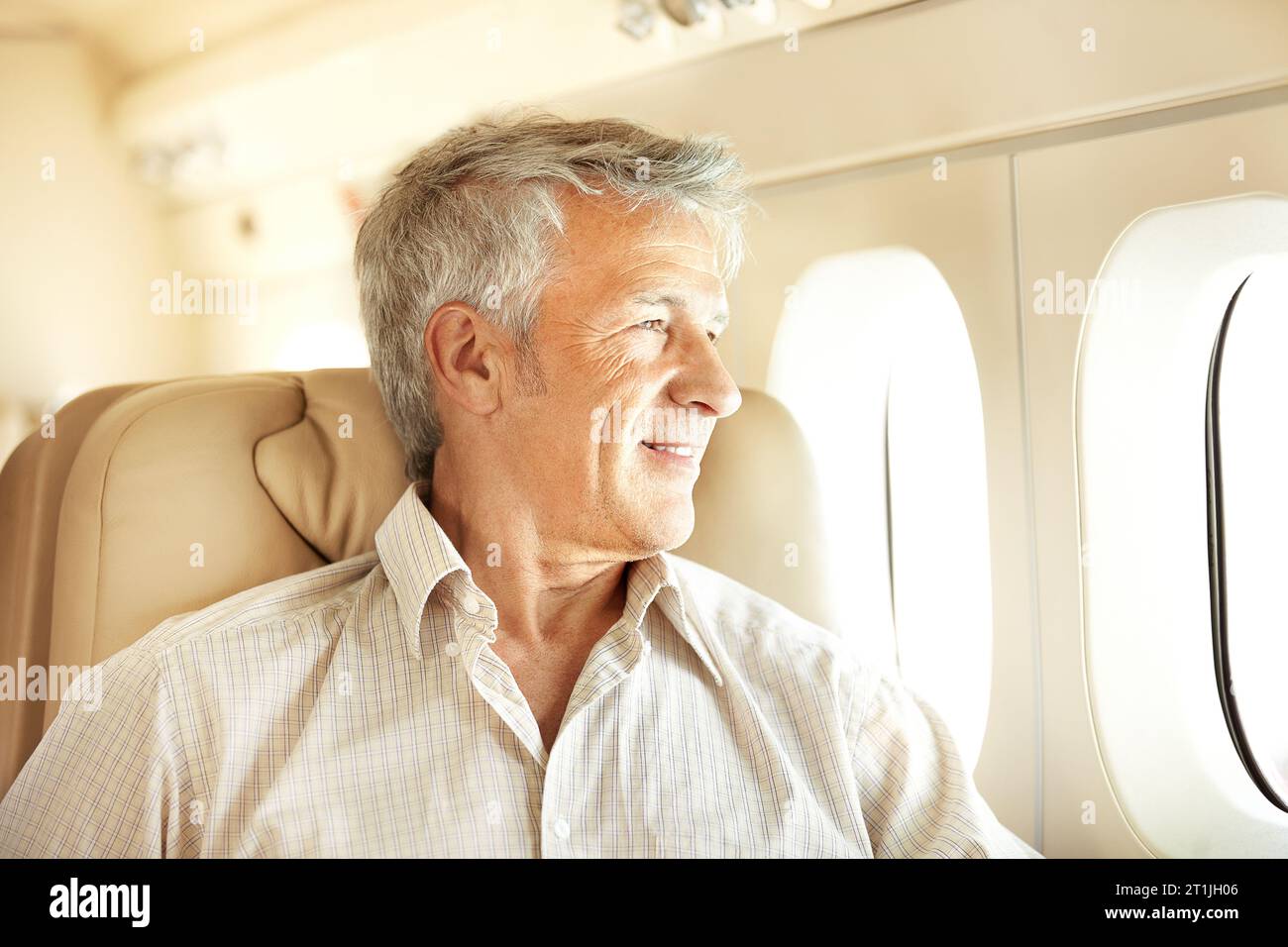 Senior man in airplane, travel and transportation with flying, window ...