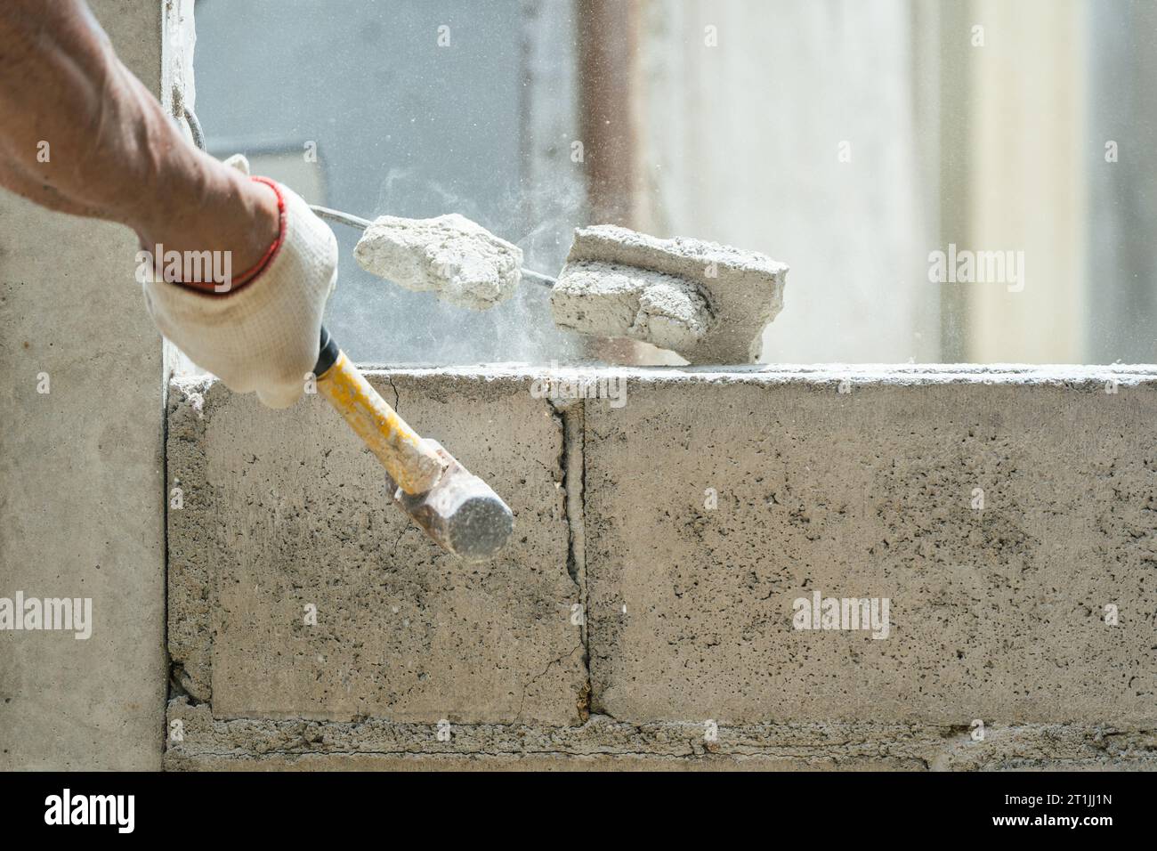 Hand of worker using hammer smashing and demolish on brick block wall ...