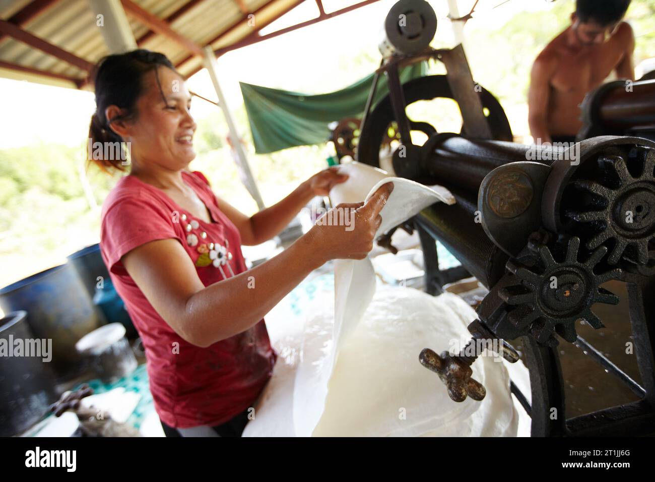 Rubber, industry and Asian woman with roller in workshop, factory and ...