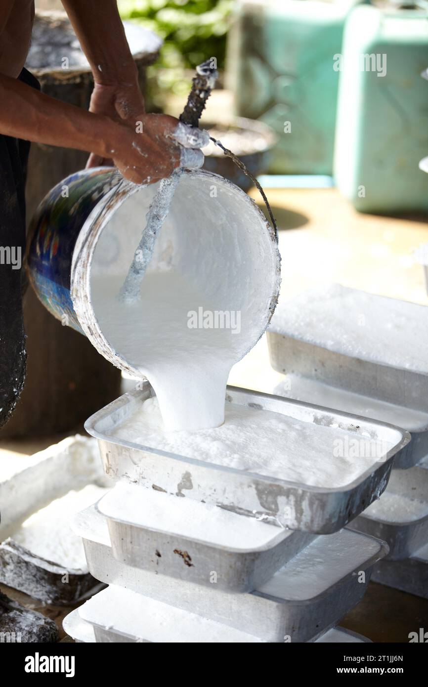 Rubber, agriculture and person with container in workshop, factory and ...