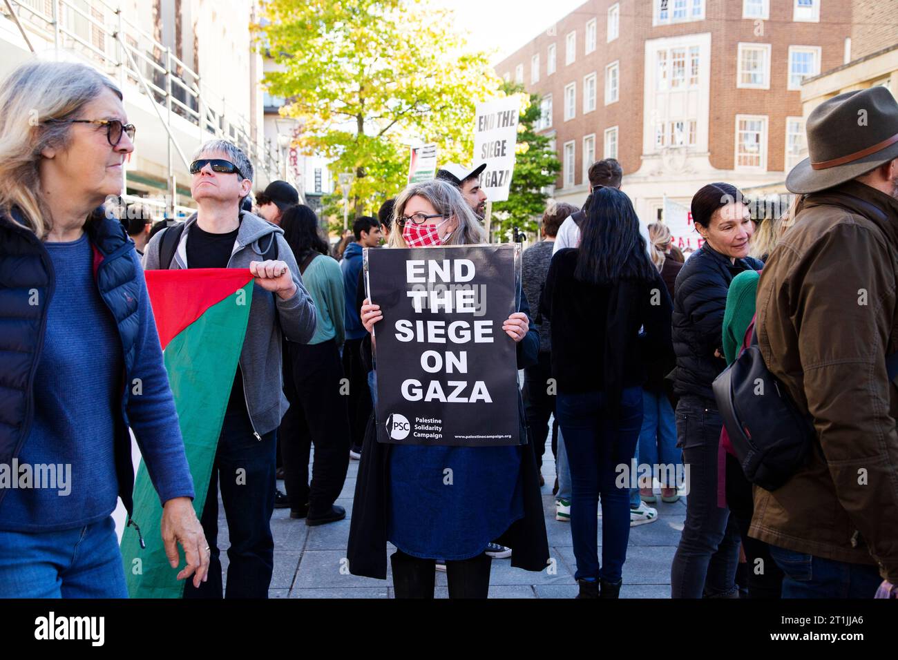 Free Palestine protest Exeter - masked lady holding 'end the siege on ...