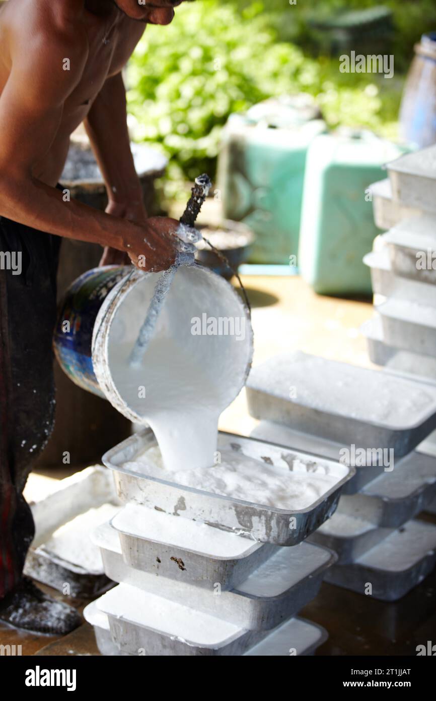 Rubber, farming and person with container in workshop, factory and ...
