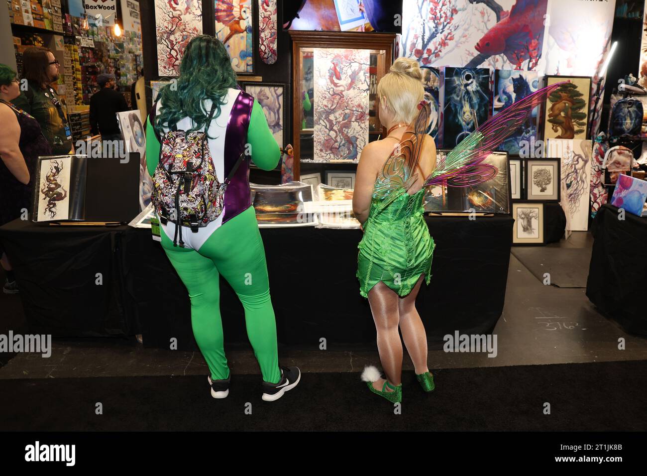 Fans in costume checks out comic books at one of the booths during the ...