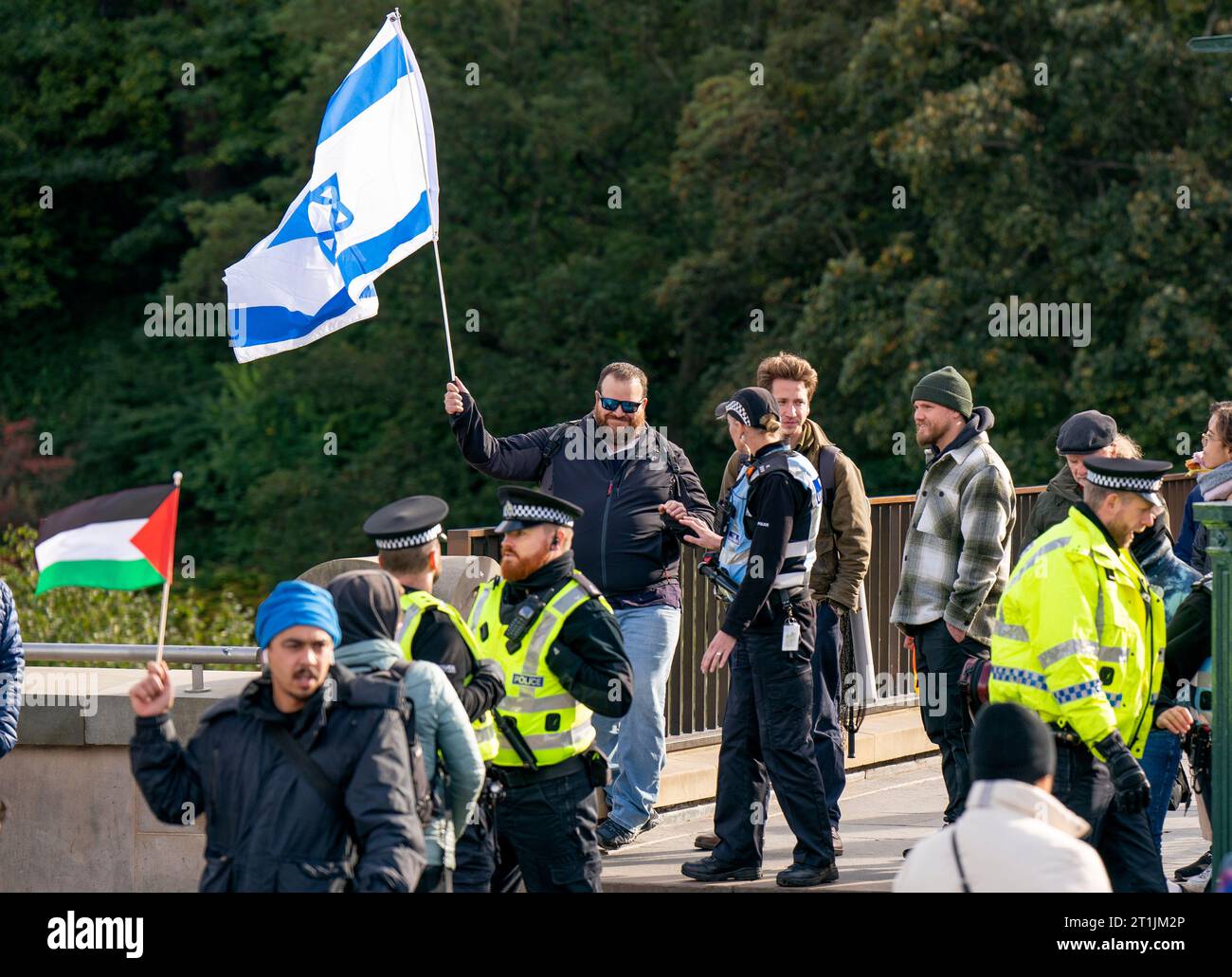 A man flies an Israeli flag during a Scottish Palestine Solidarity ...