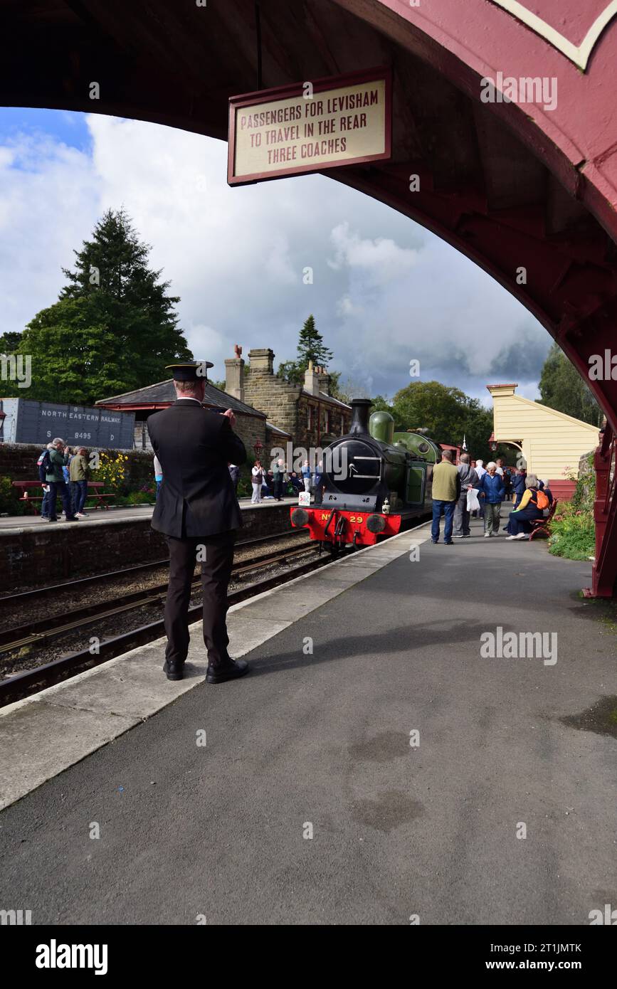 People watching a steam train arriving at Goathland station on the ...