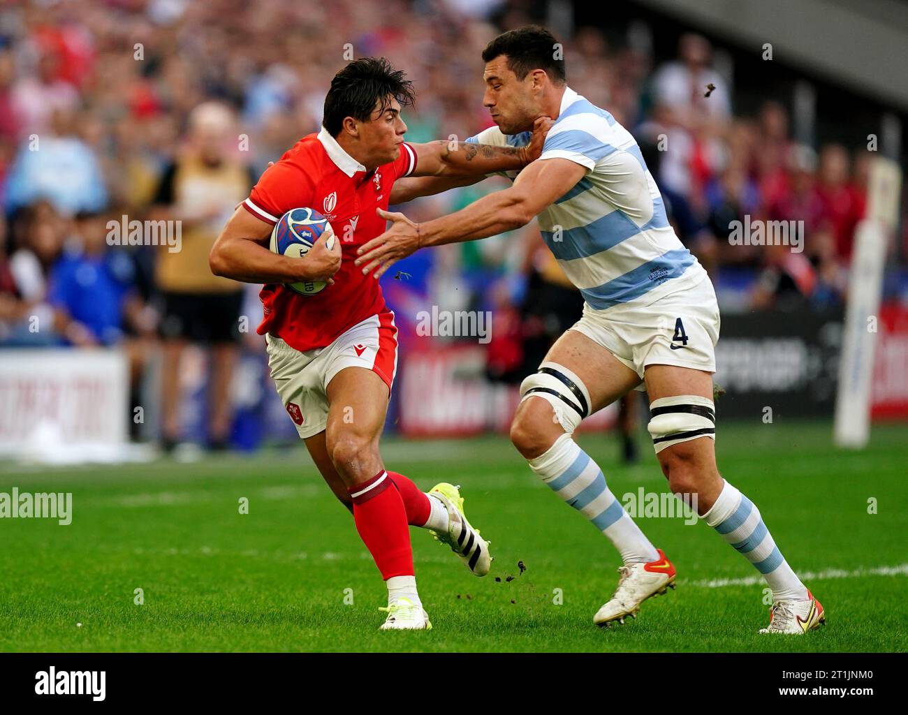 Wales' Louis Rees-Zammit (left) is tackled by Argentina's Guido Petti ...