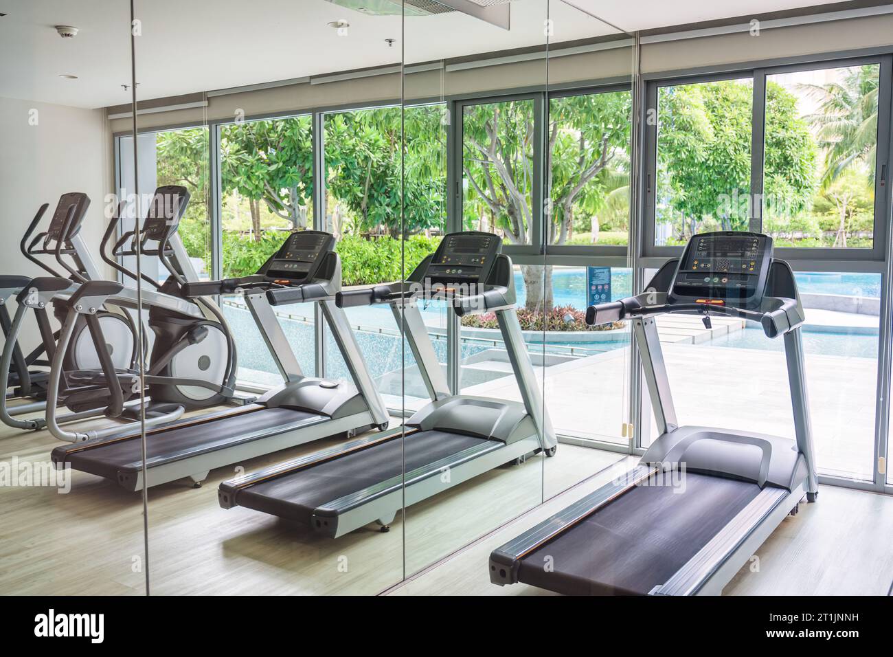 Row of nobody treadmill machine and glass window with garden view in ...