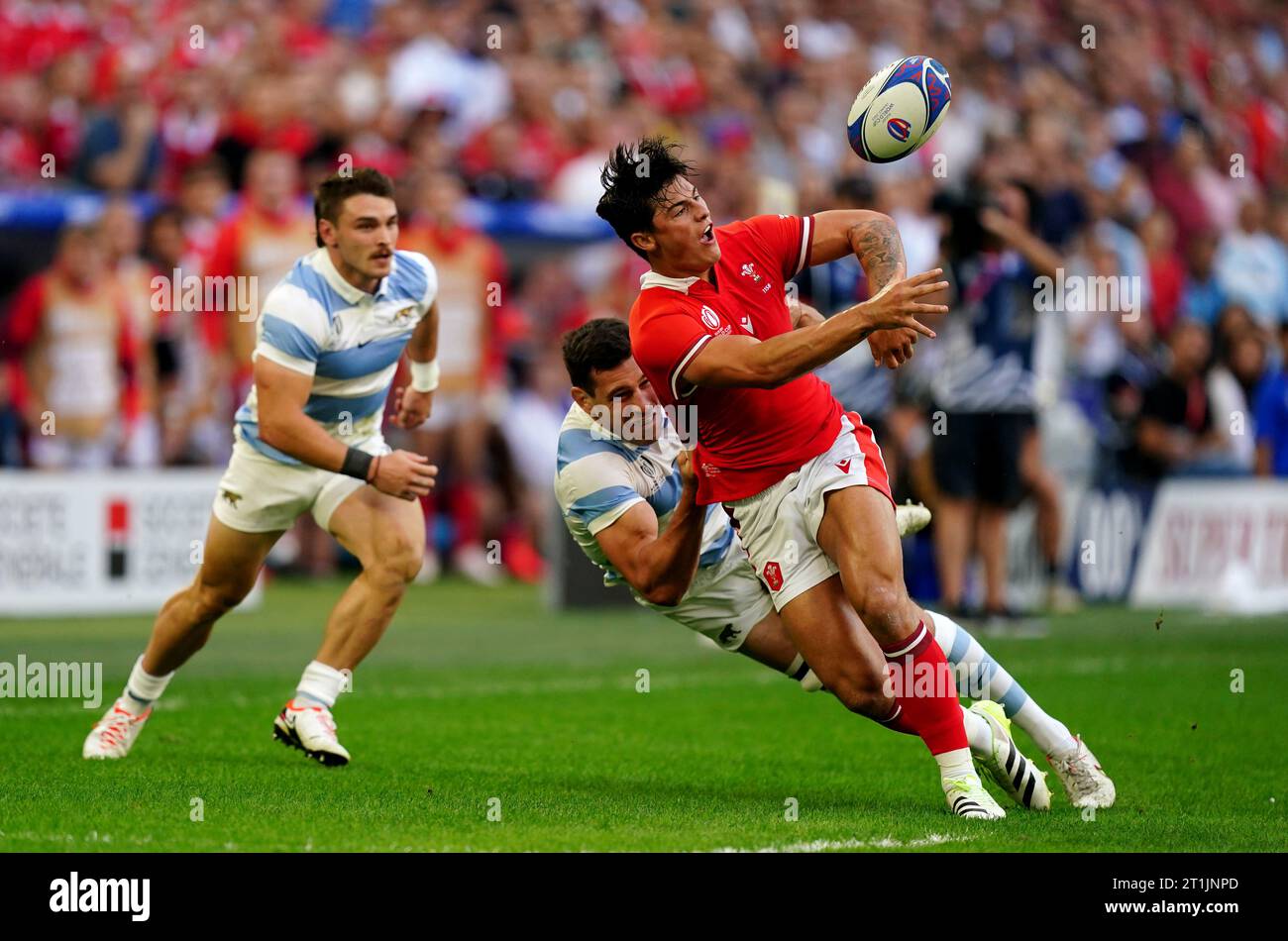 Wales' Louis Rees-Zammit (right) is tackled by Argentina's Guido Petti ...