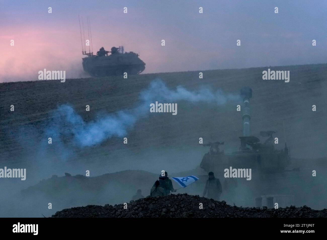 An Israeli mobile artillery unit fires a shell from southern Israel ...