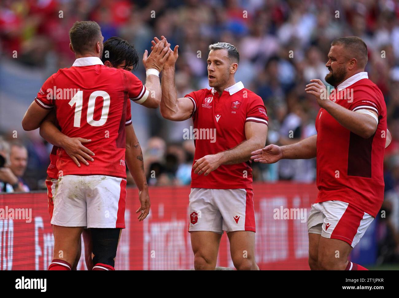 Wales' Dan Biggar (left) celebrates with his team mates after scoring a ...