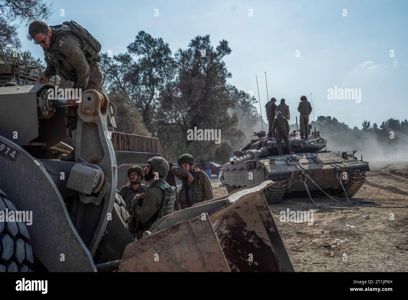 14 October 2023, Israel, Be·eri: Israeli military combat vehicles and ...