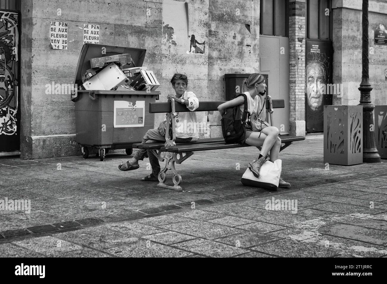 Two women sitting isolated on a street bench, Le Marais, Paris, France ...