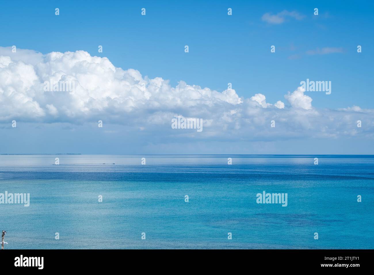 Serene blue sky with white fluffy clouds over the horizon of the ...
