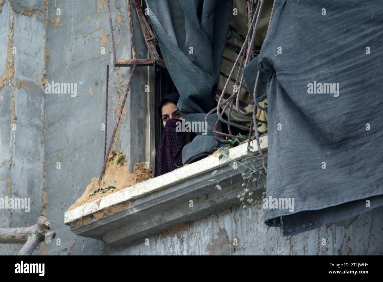 Rafah, Gaza. 14th Oct, 2023. A Palestinian woman looks at Rescuers (not ...