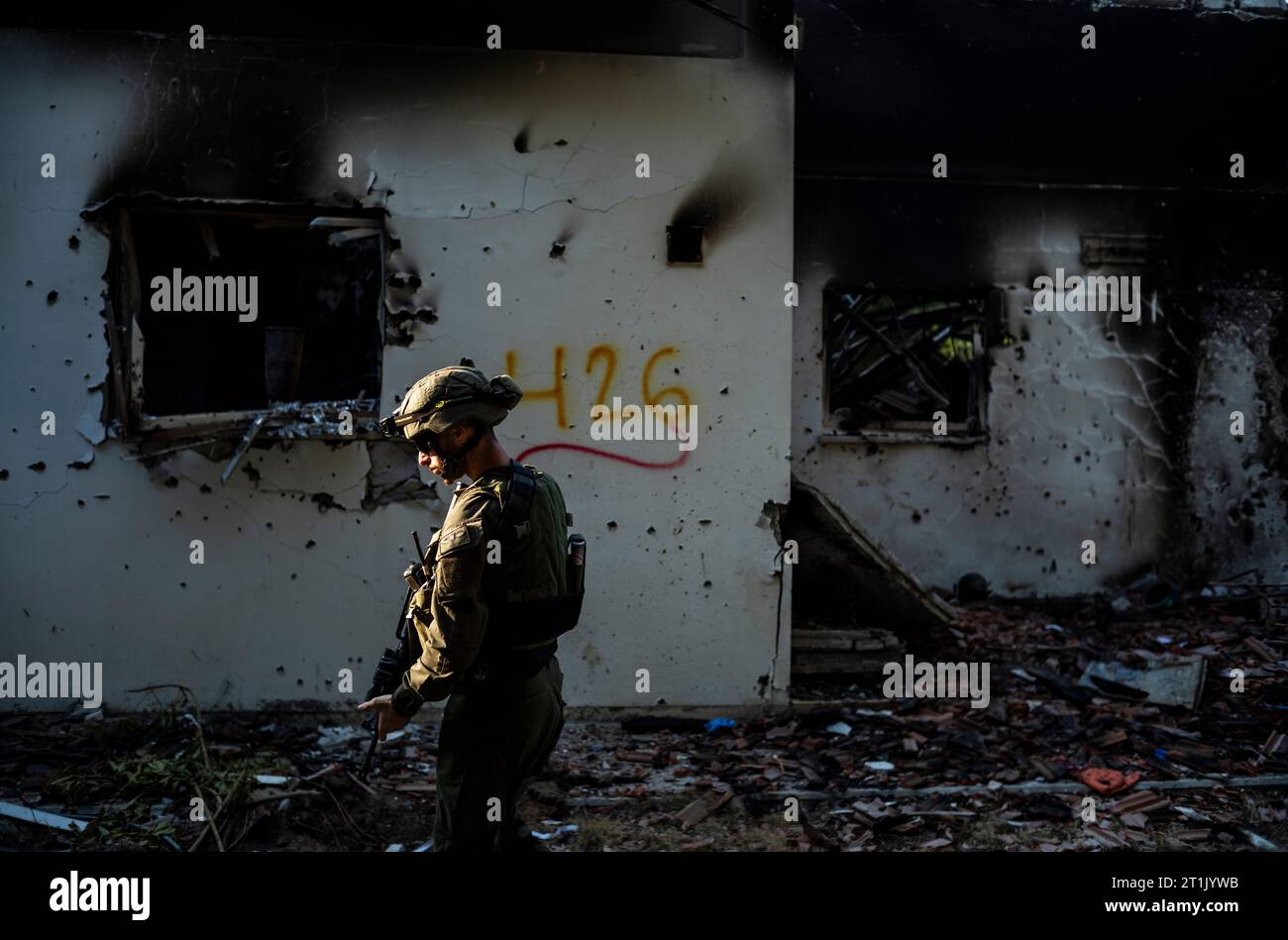 14 October 2023, Israel, Be·eri: An Israeli soldier patrols the area in ...
