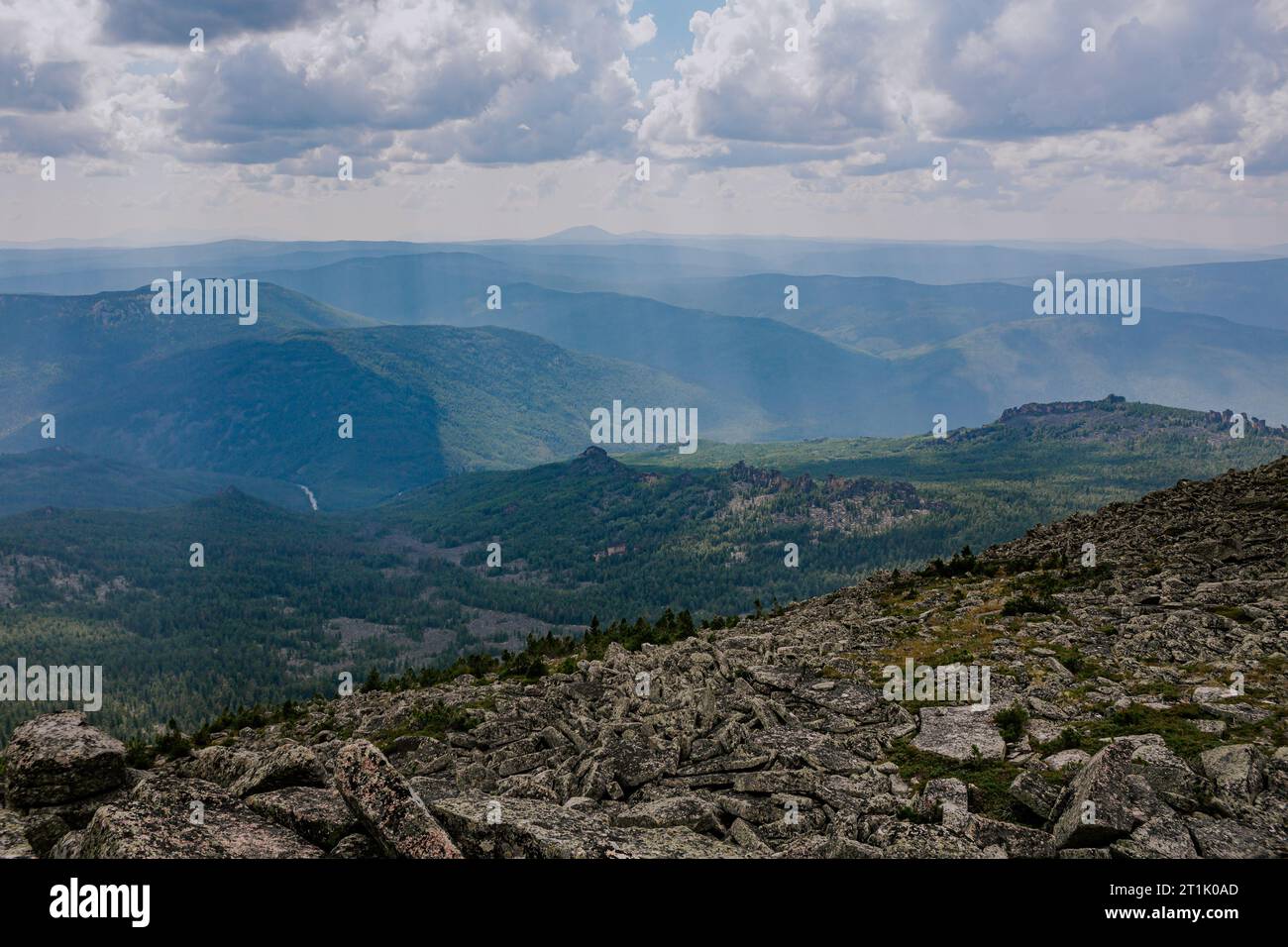 The sun's rays break through the clouds and illuminate the rocks and ...