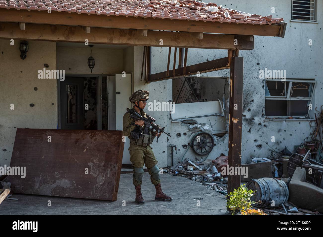 14 October 2023, Israel, Be·eri: An Israeli soldier patrols the area in ...