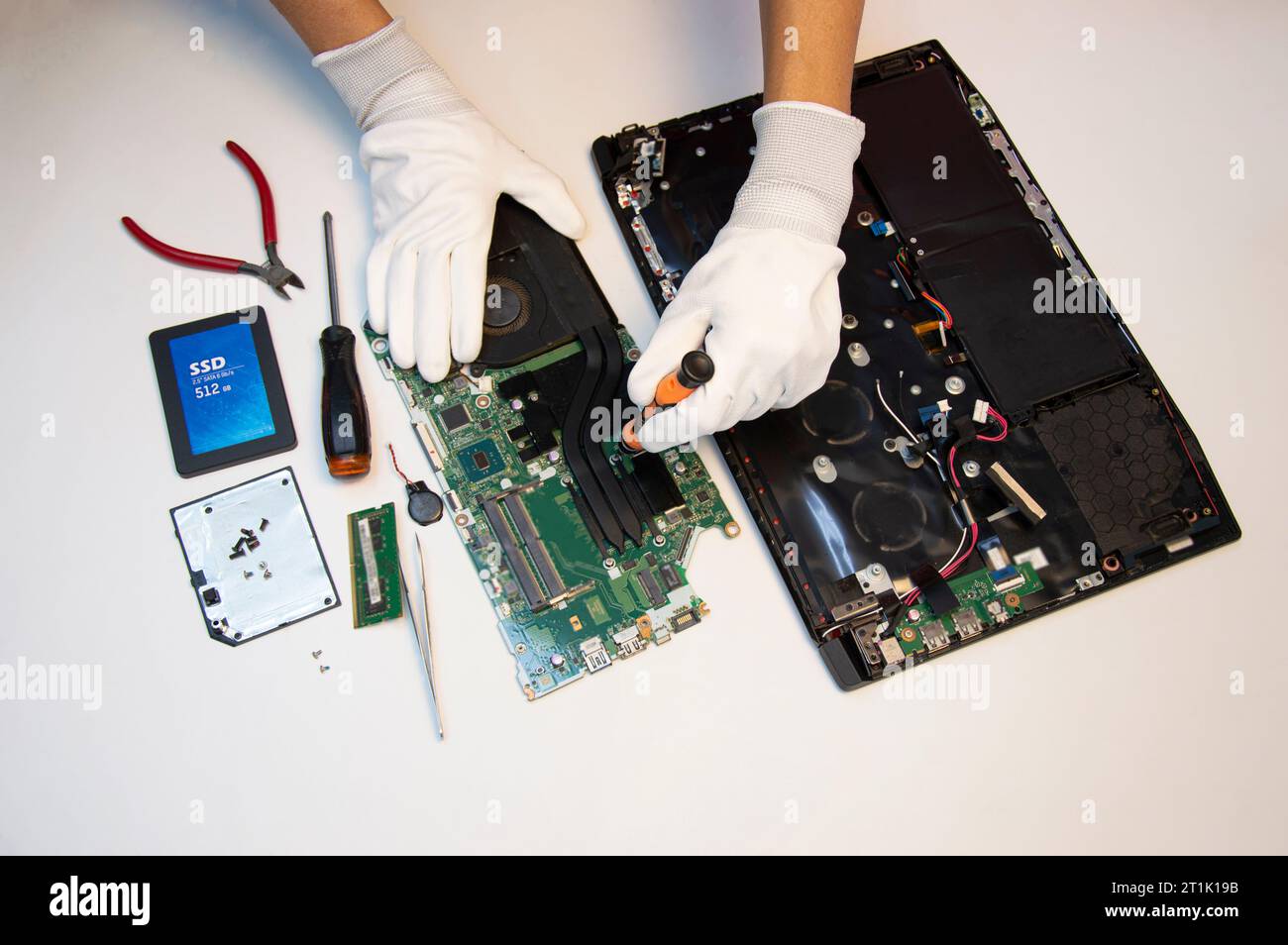 Top view. Technician repairing notebook computer, repairing motherboard ...