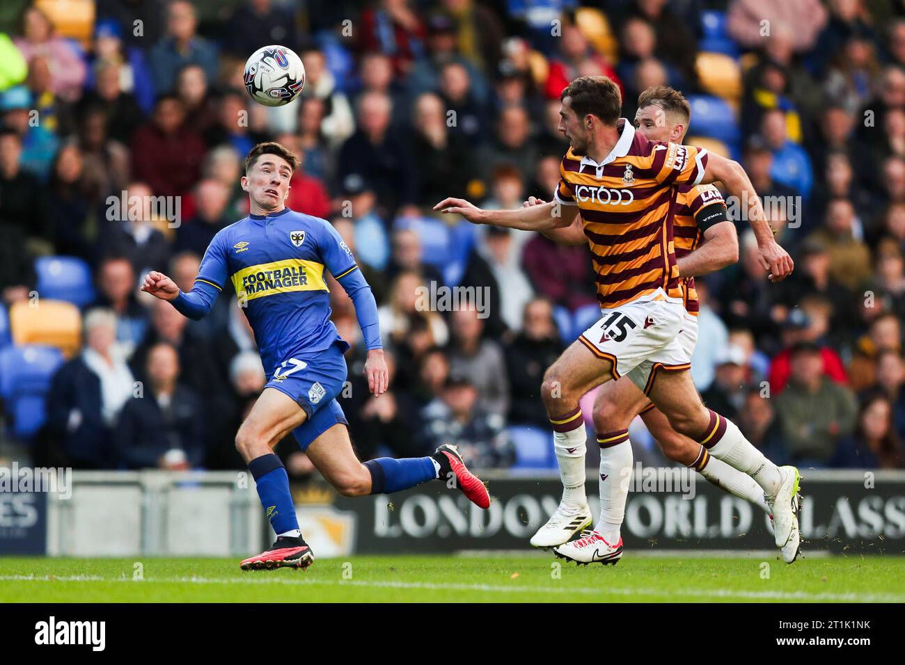 AFC Wimbledon's Ryan McLean feels pressure from Bradford City's Sam ...