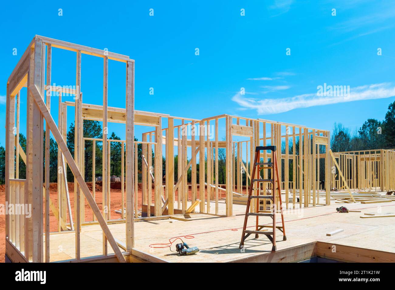 Construction work in progress an unfinished house with wooden framing ...