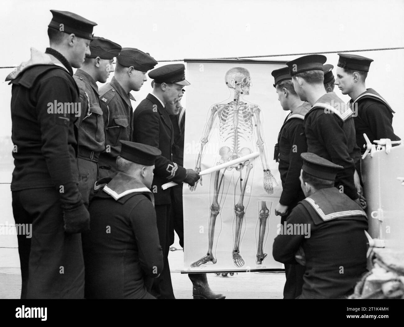 The ship's doctor giving a lecture on first aid to crew members on HMS ...