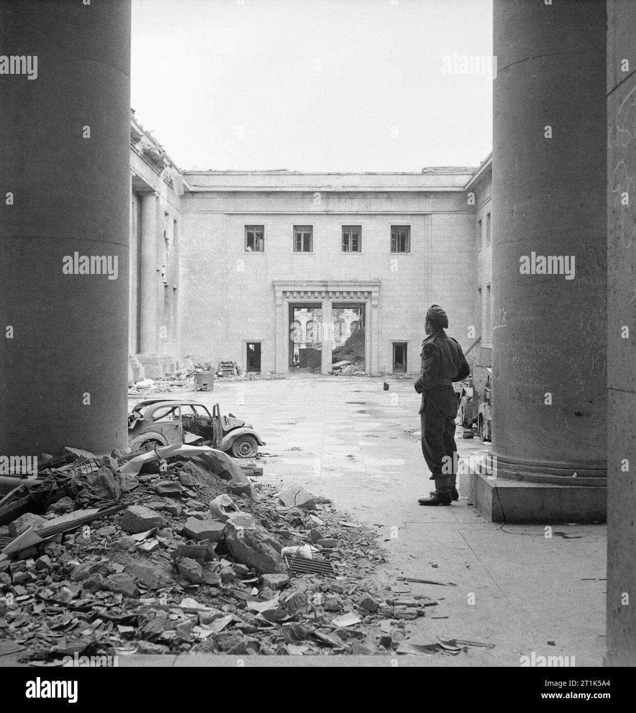 Sergeant R S Baker of the Army Film and Photograph Unit standing in the ...