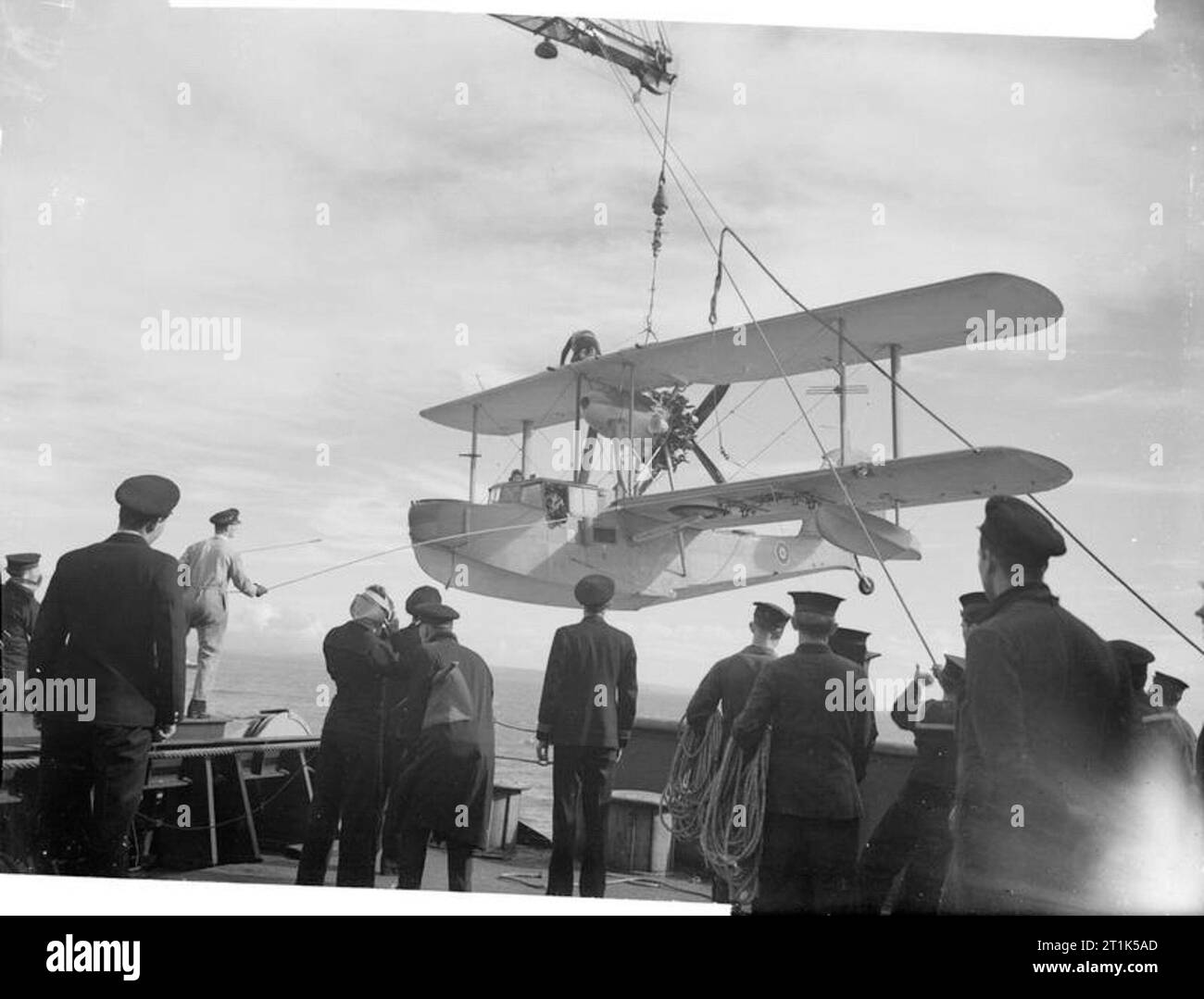 HMS Howe. August 1942. One of the ship's aircraft being hauled inboard ...