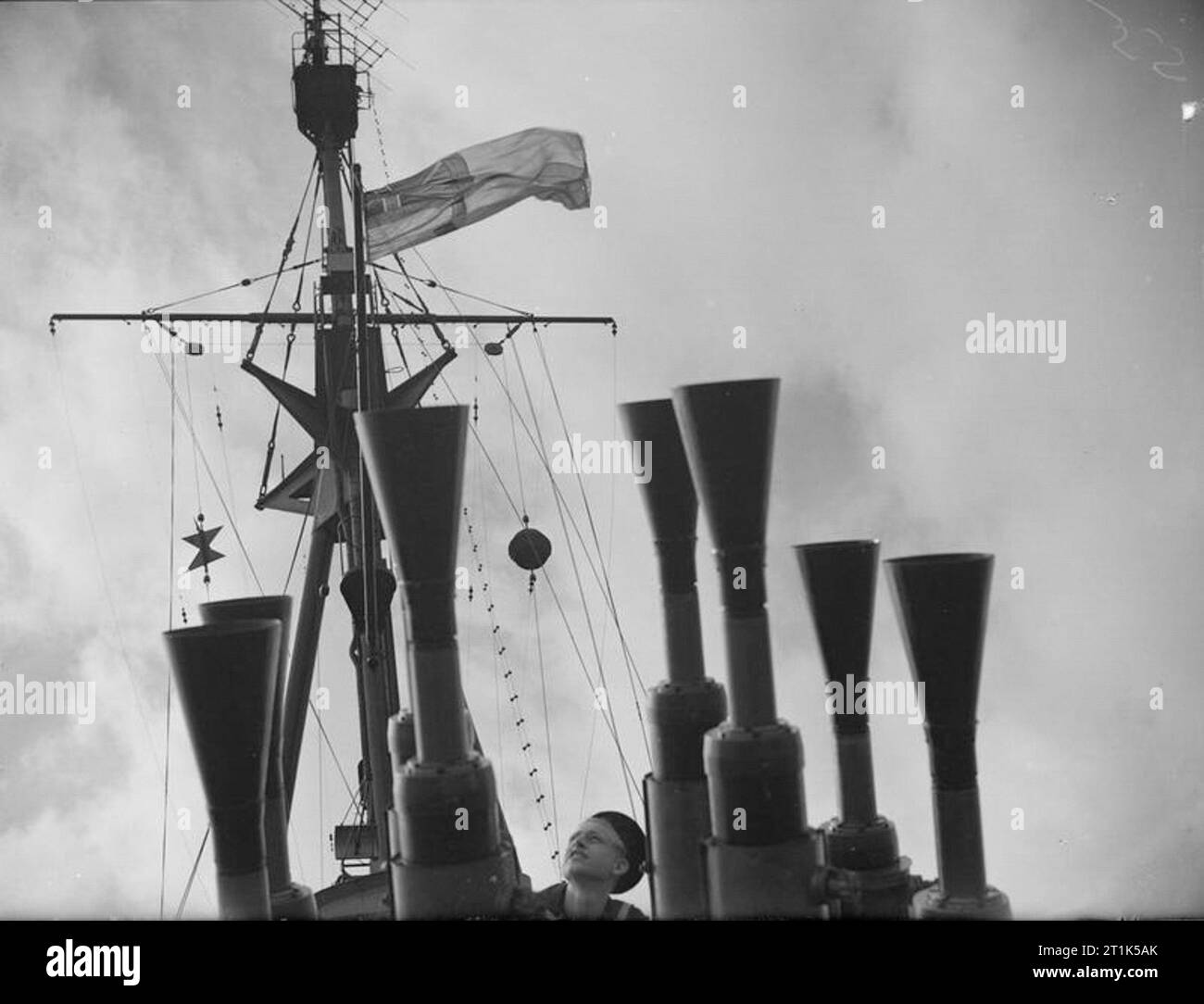 HMS Howe. August 1942. The White Ensign hoisted at the peak on HMS HOWE ...