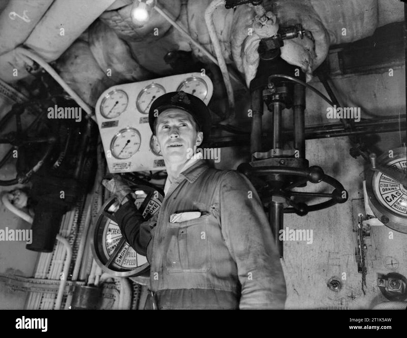 HMS Howe. August 1942. Engineer Officer in the engine room relaying an ...