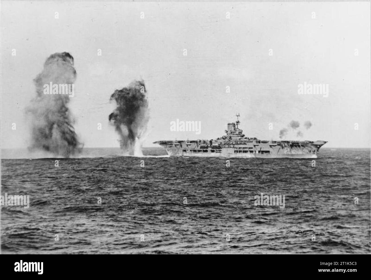 The Royal Navy during the Second World War Bombs falling astern of HMS ...
