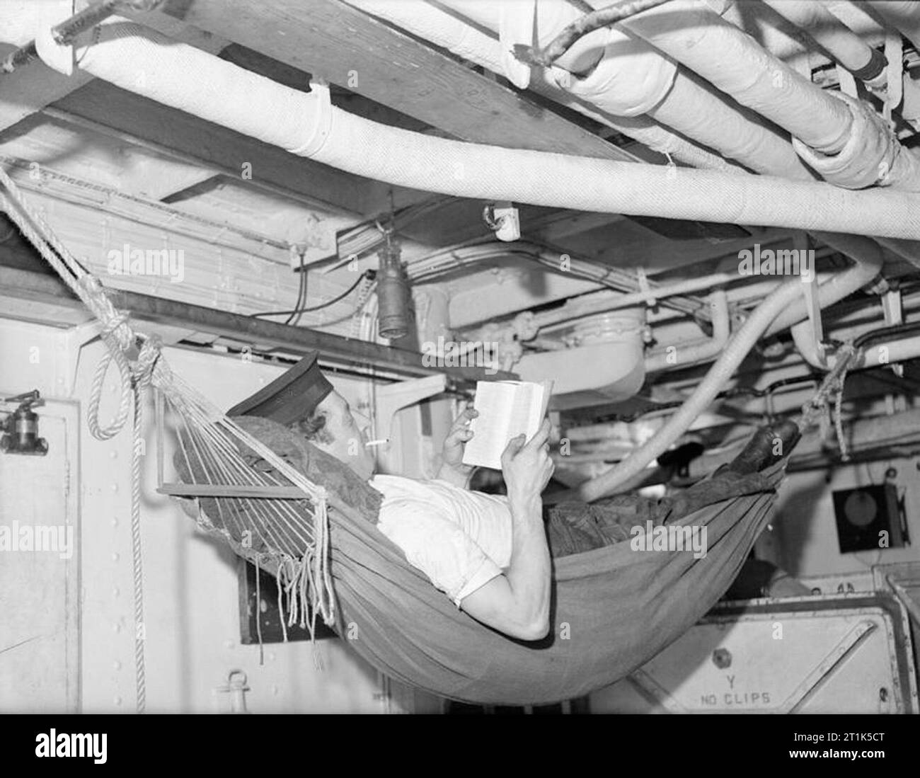 Books For the Navy. 20 August 1942. Men on board a warship enjoying ...