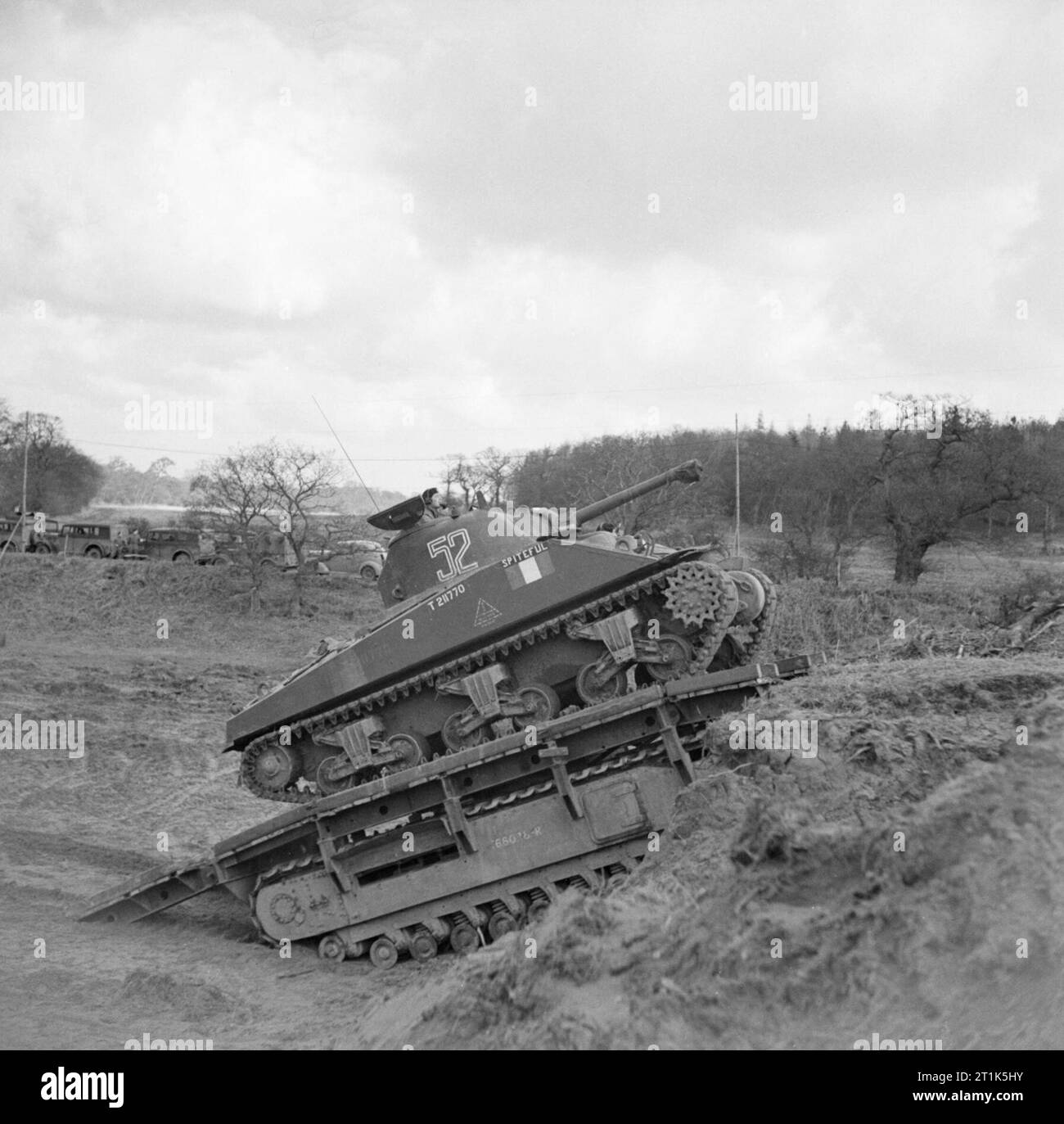 Sherman tank using a Churchill 'Ark' armoured ramp carrier to climb ...