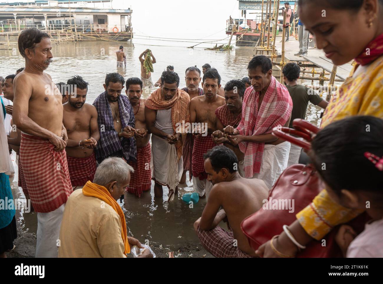 Hindu devotees perform the 'Tarpan' ritual during Mahalaya prayers ...