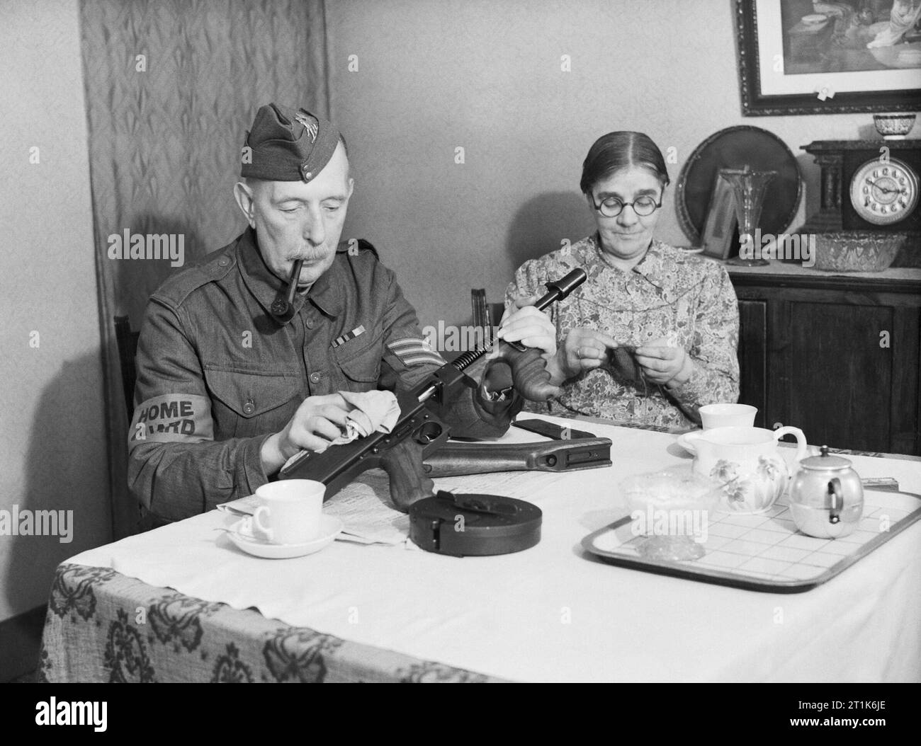 A veteran sergeant in the Dorking Home Guard cleans his Tommy gun at ...