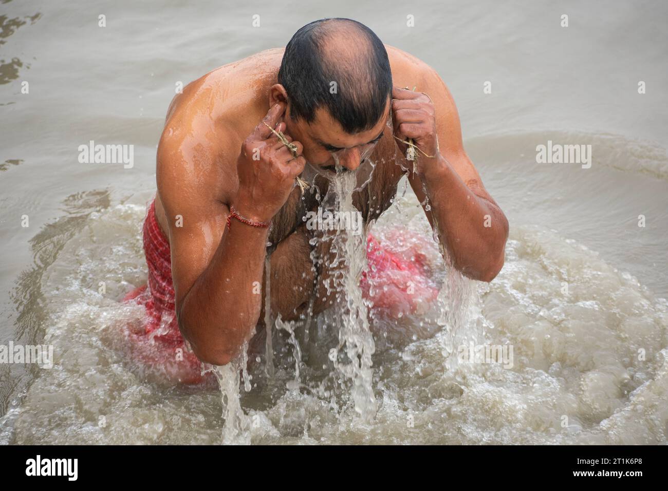 Hindu devotees perform the 'Tarpan' ritual during Mahalaya prayers ...