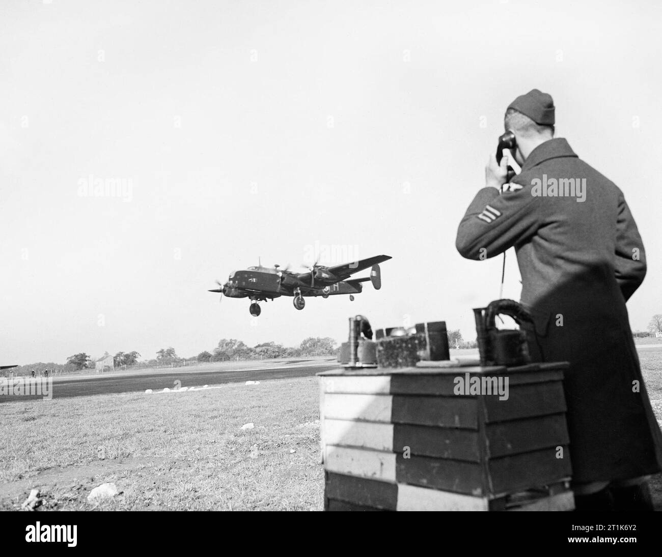 A sergeant on flying control duty reports the landing of a Halifax Mk V ...
