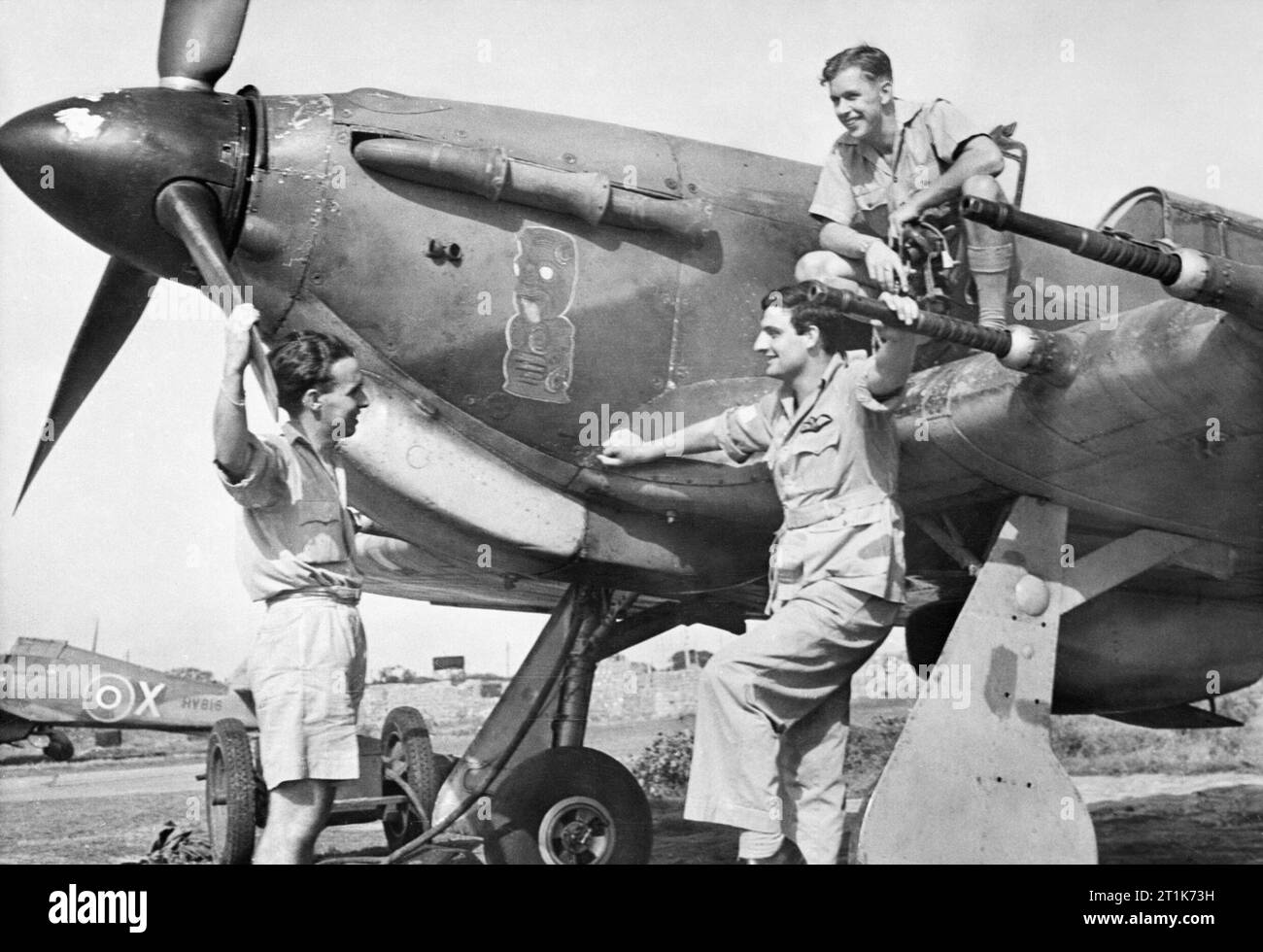 Pilots discuss a sortie by the nose of a Hawker Hurricane Mk IIC of No ...