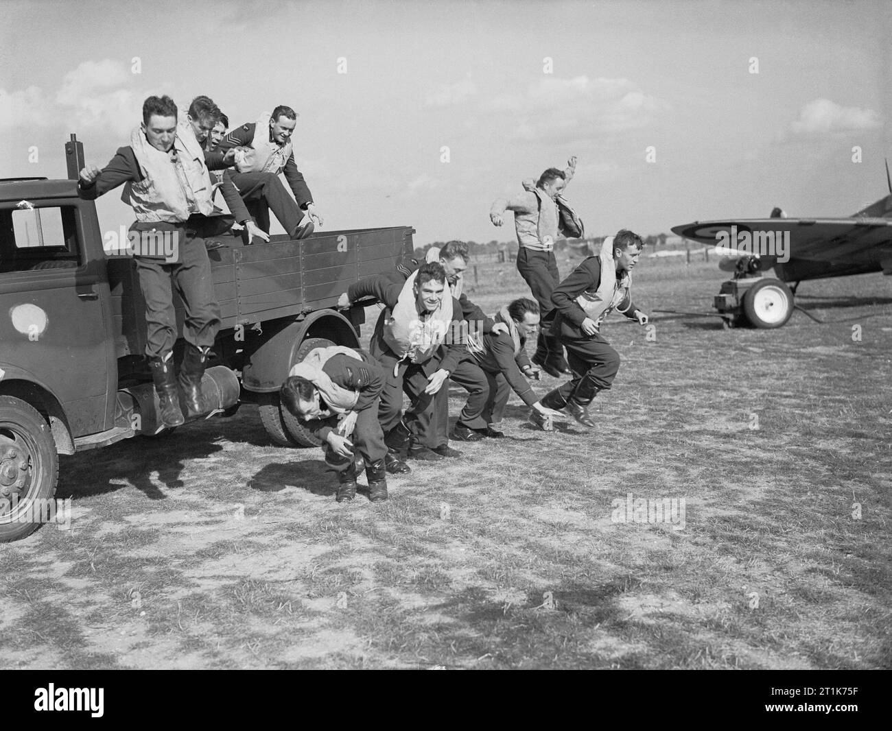 Pilots of No. 19 Squadron RAF stage a mock 'scramble' from the back of ...