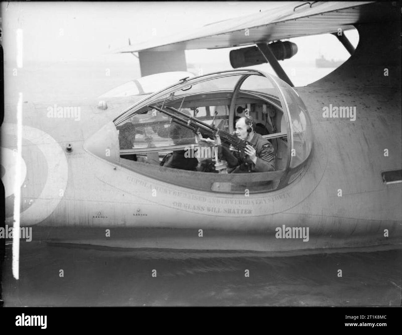 Royal Air Force Coastal Command, 1939-1945. An air gunner demonstrates ...