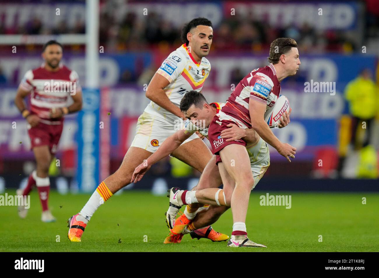 Jai Field #1 of Wigan Warriors is held in the tackle during the Betfred ...