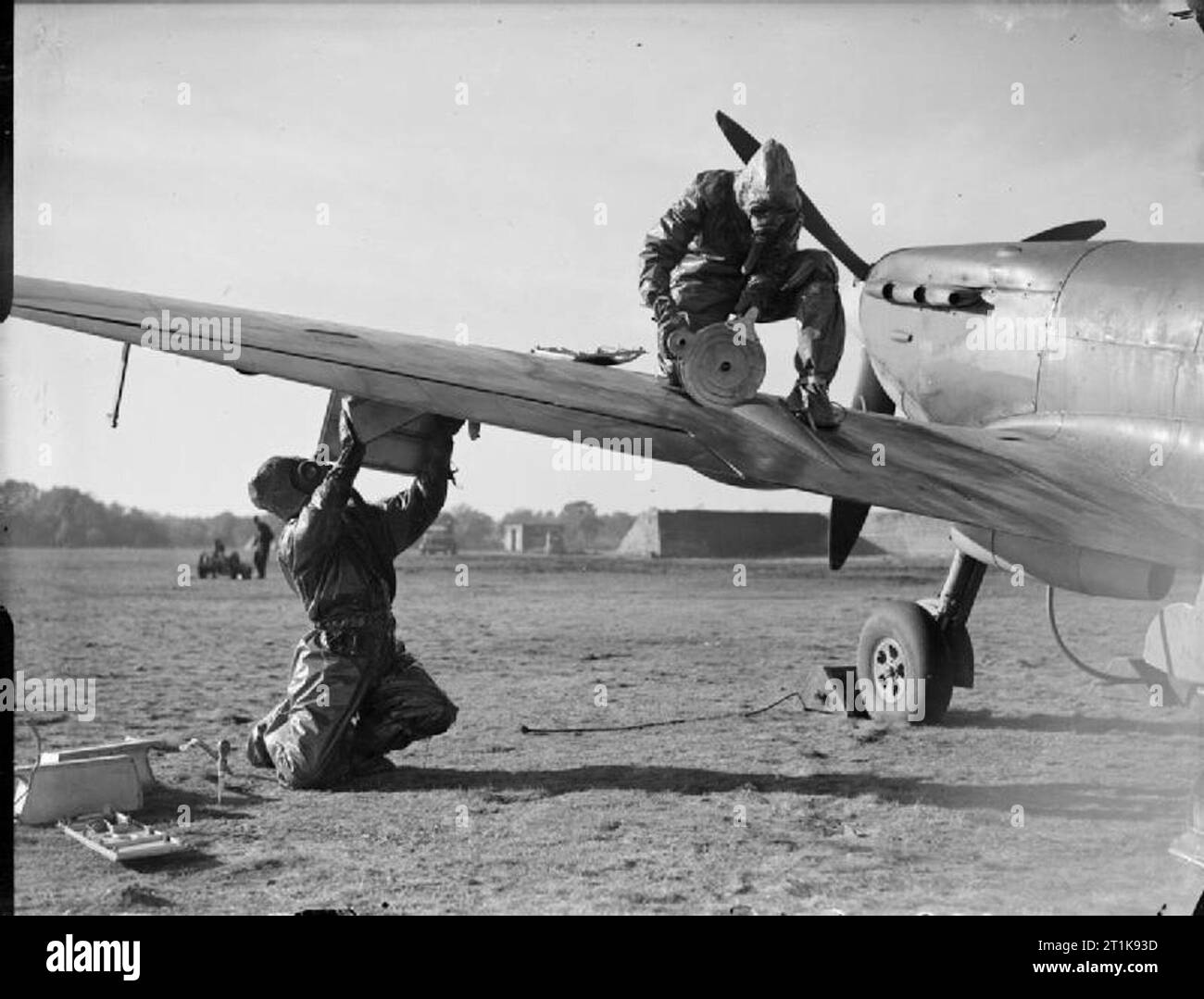 Royal Air Force Fighter Command, 1939-1945. Armourers of No. 403 Squadron RCAF, wearing anti-gas ...