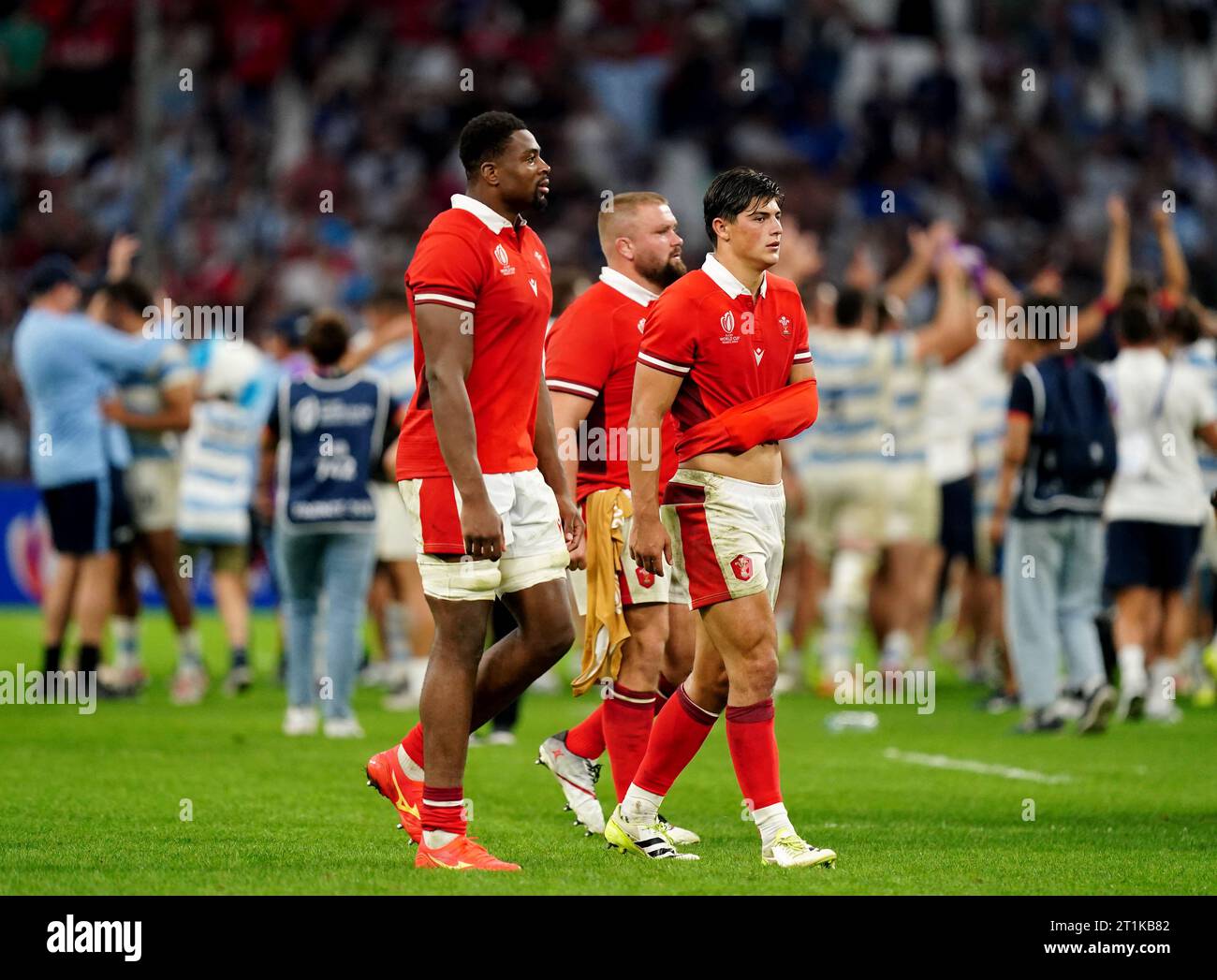 Wales' Christ Tshiunza (left) and Louis Rees-Zammit leave the field ...