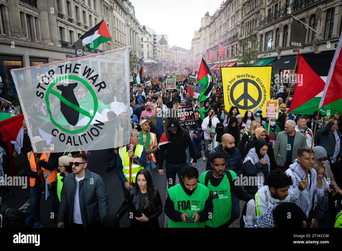 London, UK. 14th Oct, 2023. Protesters with banners and placards march ...