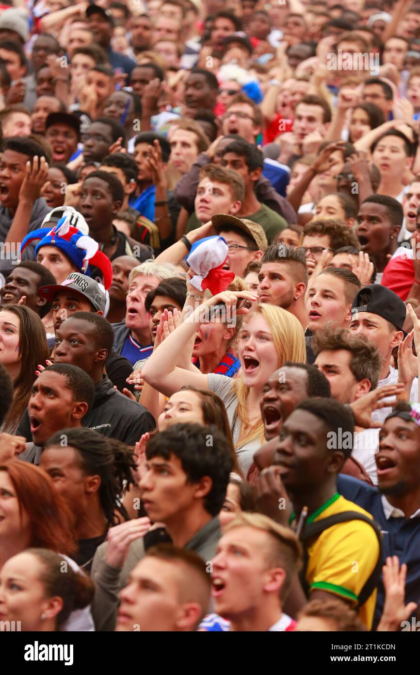 Crowds watching the World Cup Soccer on a live large TV screen in front ...