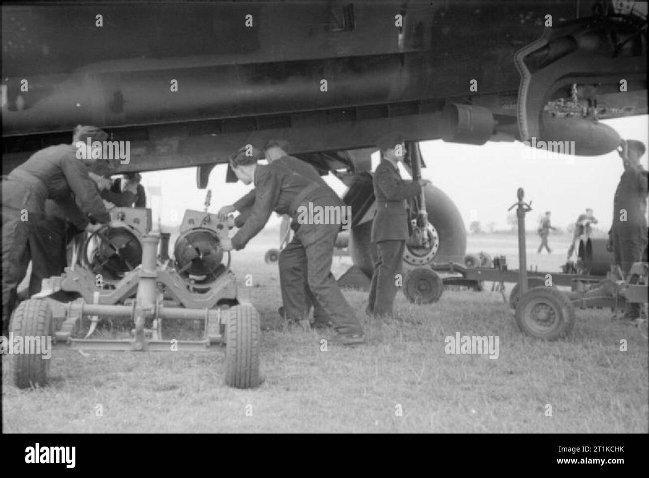Armourers loading 1,000-lb GP bombs into a Short Stirling of No. 218 ...