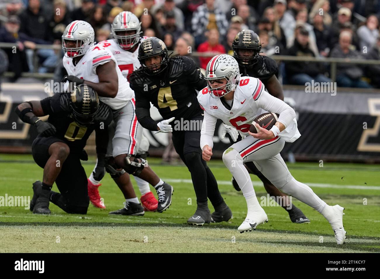 Ohio State quarterback Kyle McCord (6) runs past Purdue linebacker ...