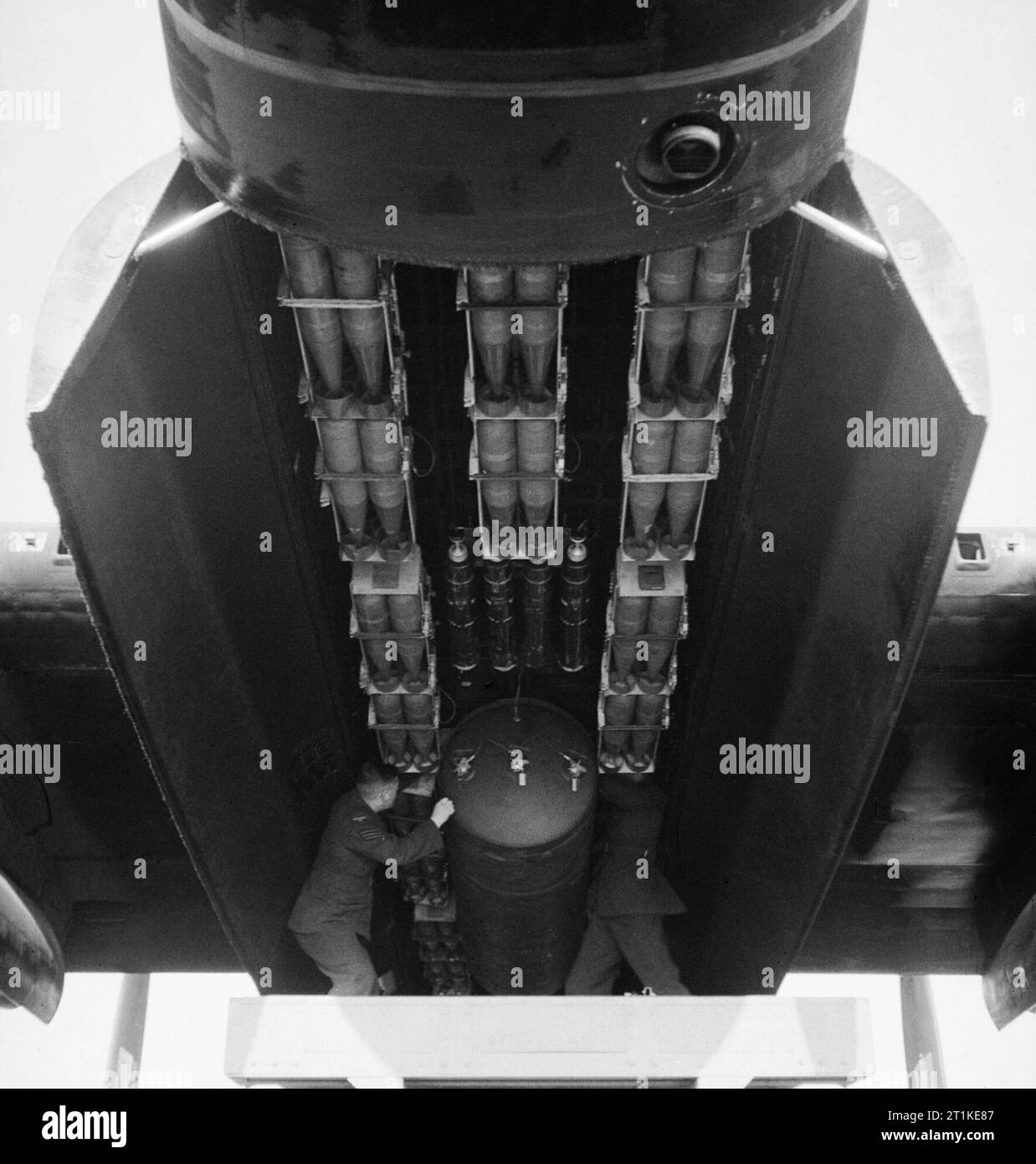 Armourers checking the bomb load of an Avro Lancaster of No. 207 Squadron RAF at Syerston ...