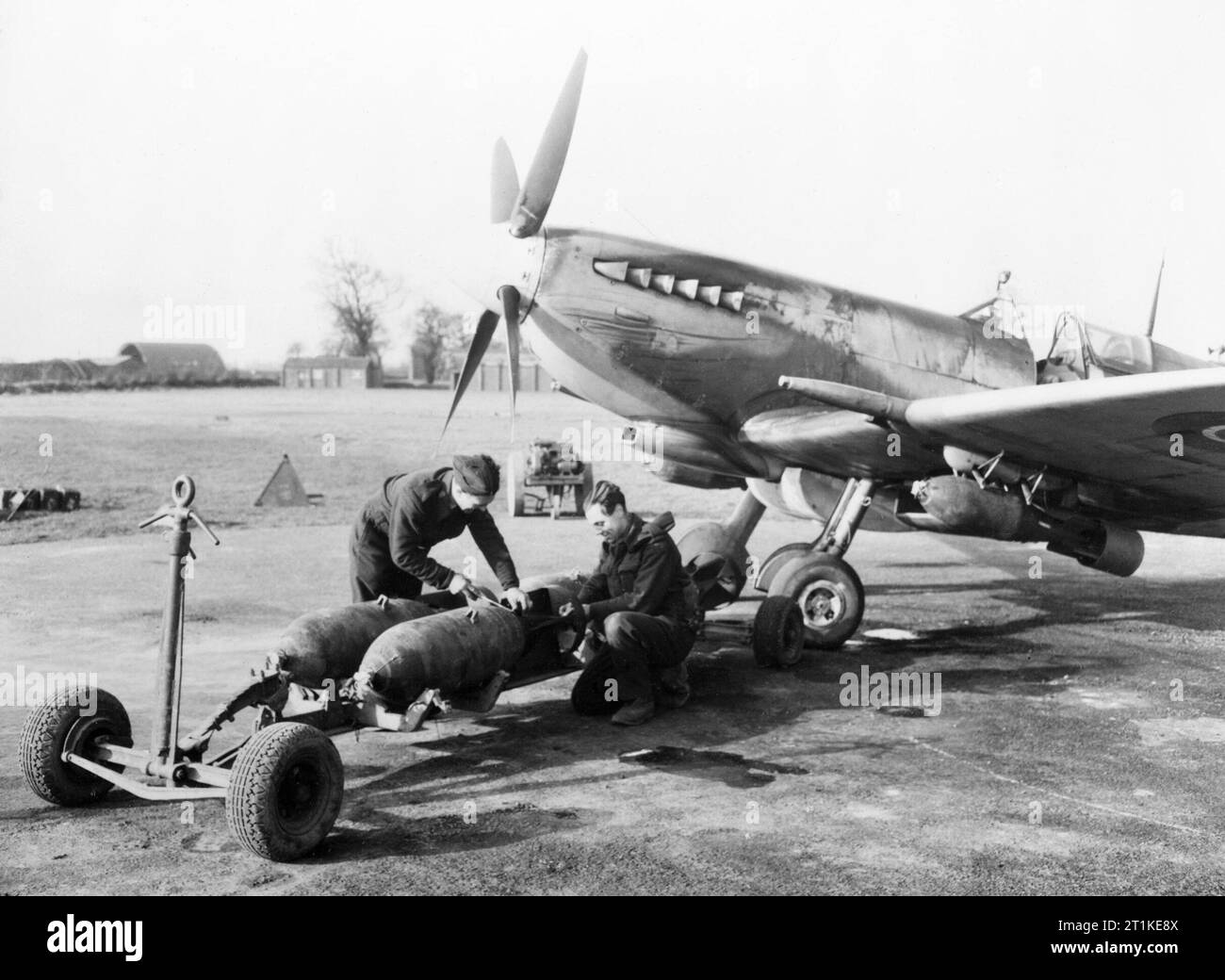Armourers loading bombs onto a Spitfire Mk XVI of No. 603 Squadron RAF ...